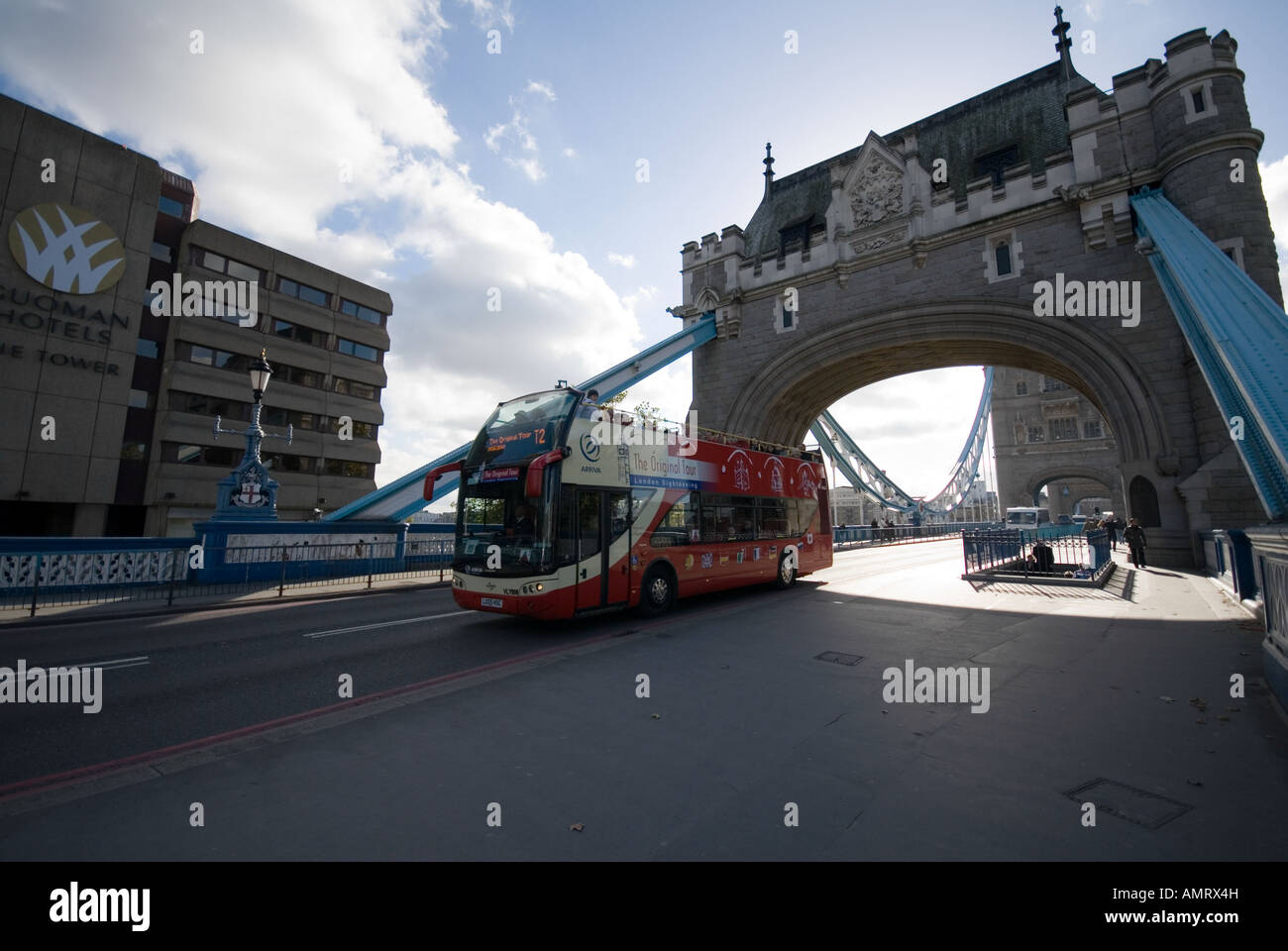 A red Bus pass through the Tower Bridge London Stock Photo - Alamy