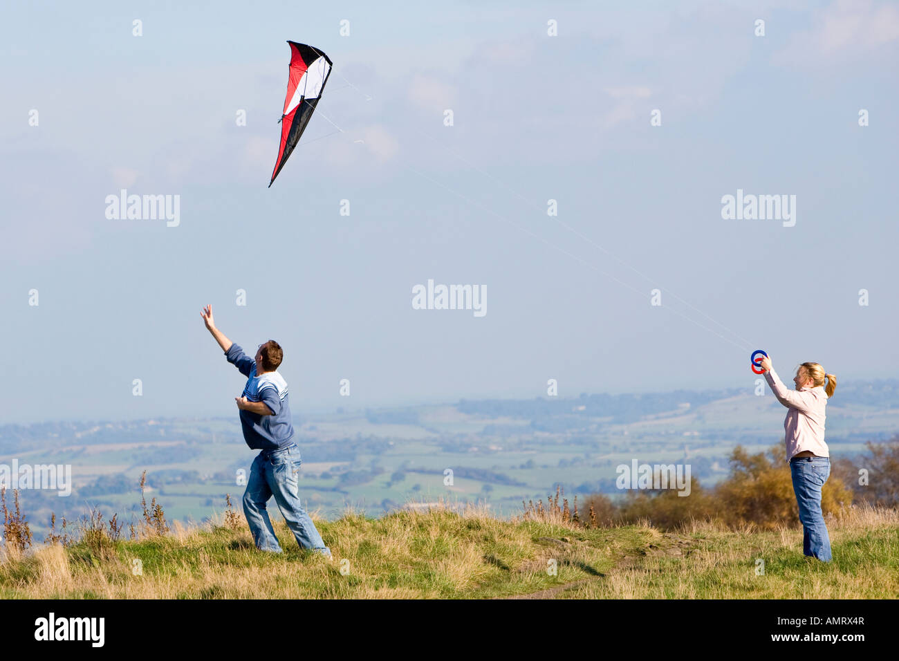 English Countryside young couple flying a kite Stock Photo - Alamy