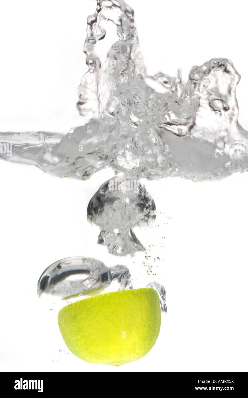 lemon splashing into water Stock Photo - Alamy