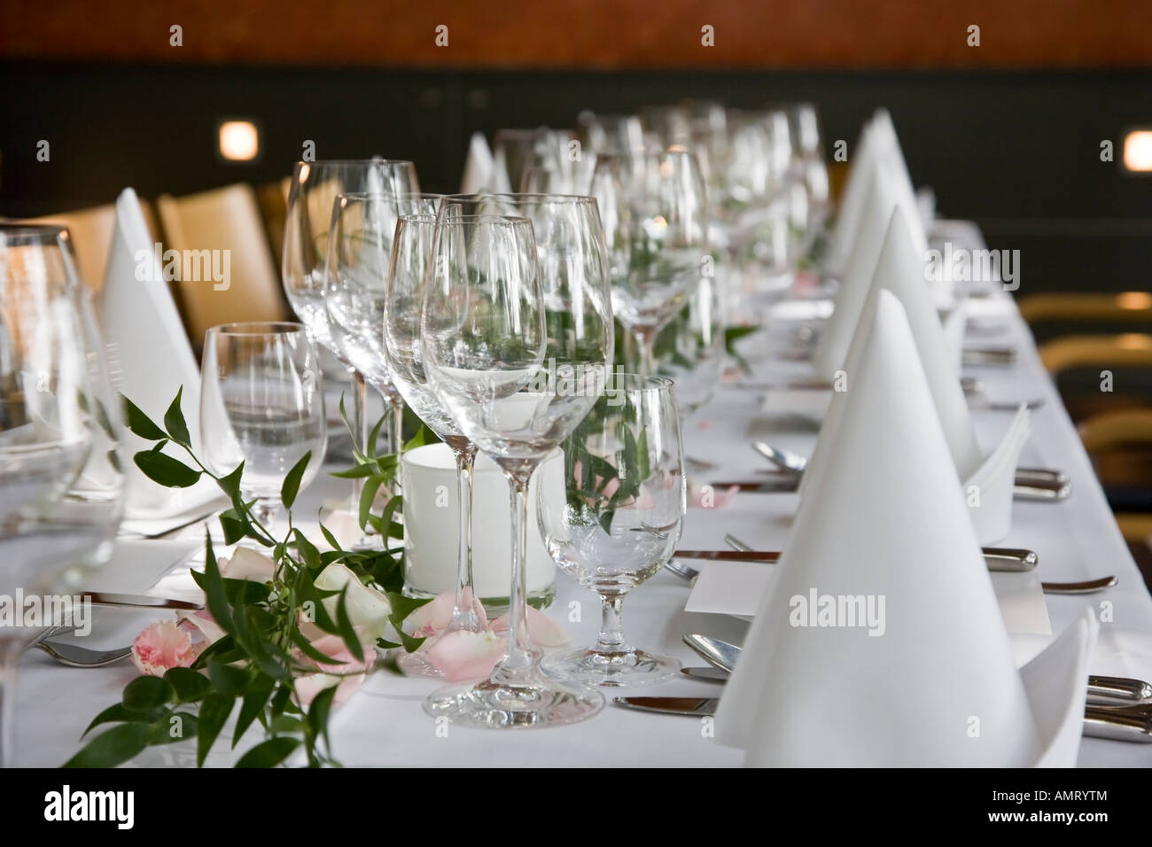 Well-laid table with white folded serviettes and wine glasses Stock ...