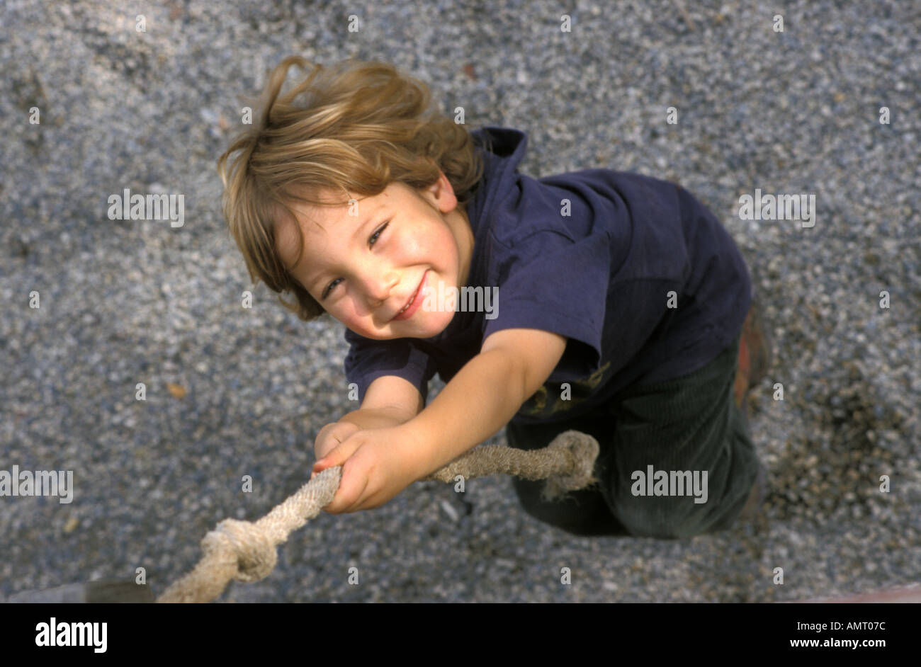 Boy pulling rope, elevated view Stock Photo - Alamy