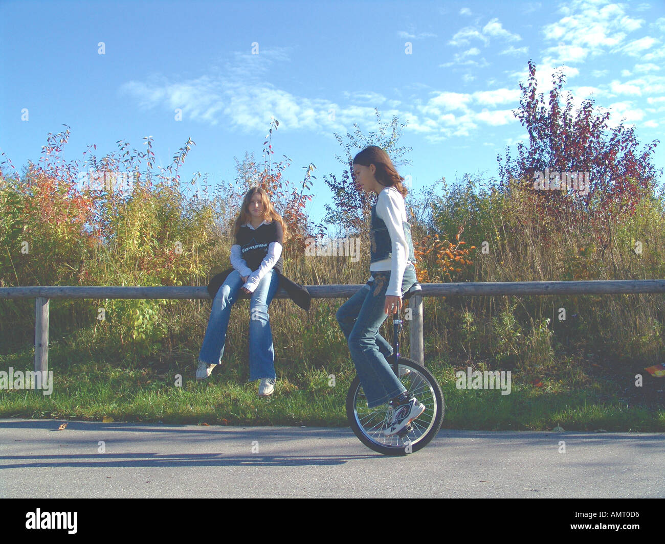 children two girls 10 14 years unicycle cycle sport circus skill ...