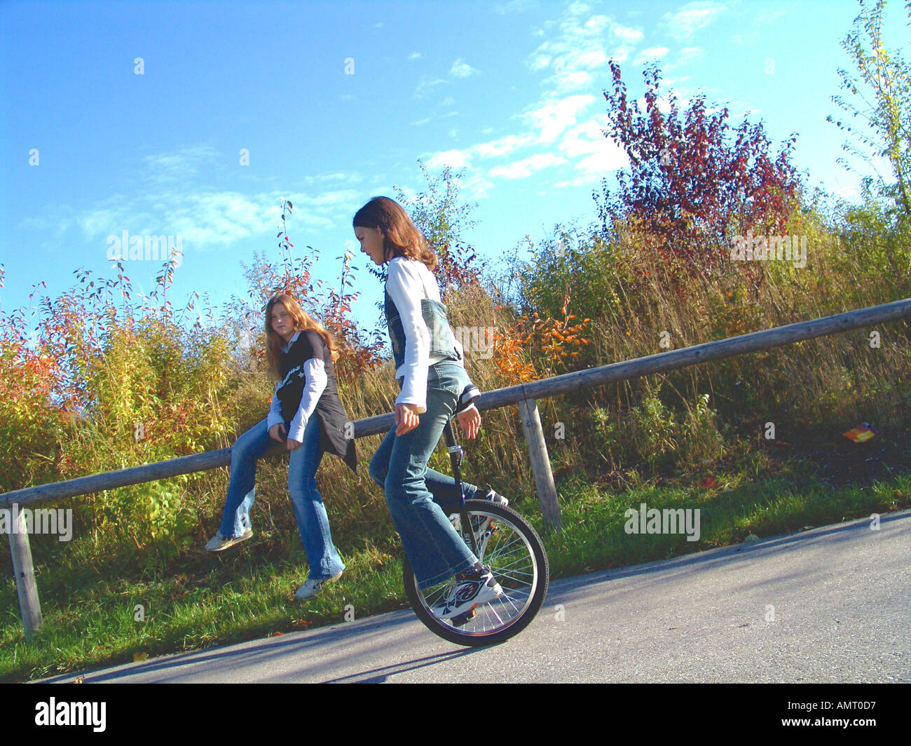 children two girls 10 14 years unicycle cycle sport circus skill ...