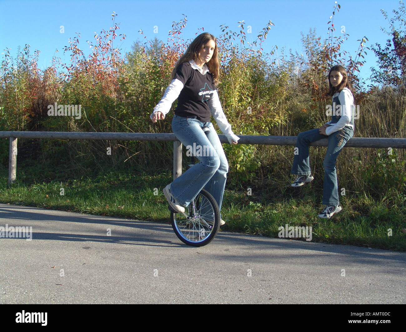 children two girls 10 14 years unicycle cycle sport circus skill ...