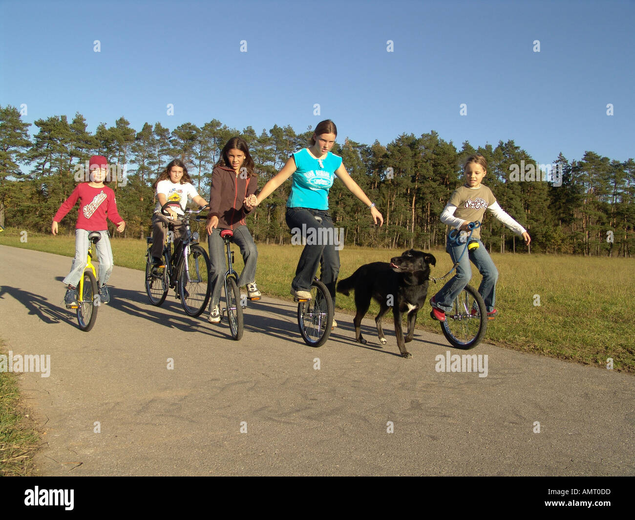 children two girls 10 14 years unicycle cycle sport circus skill ...