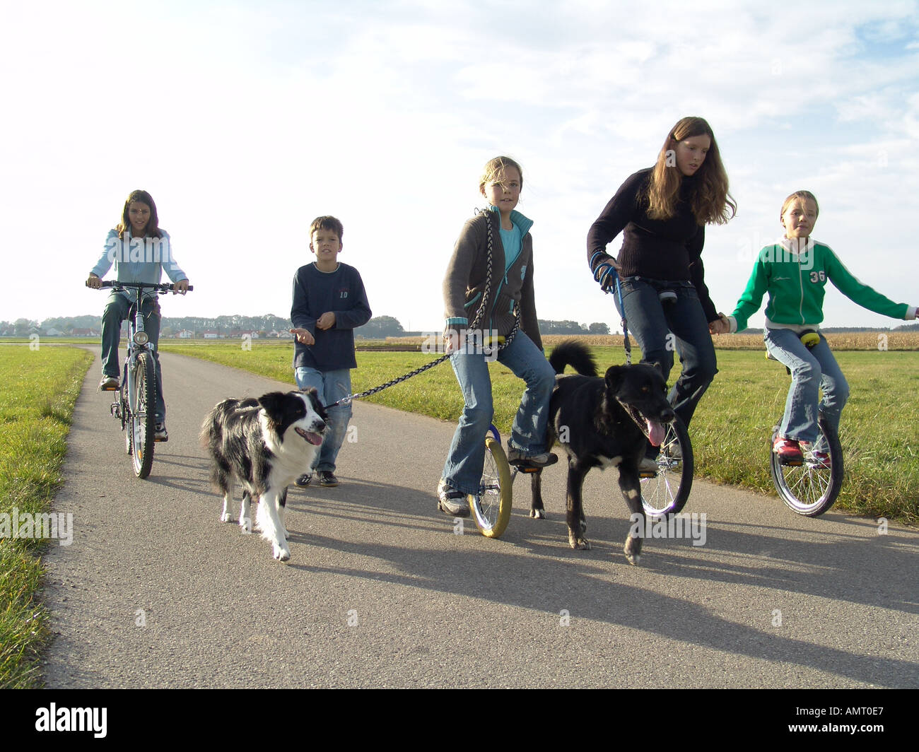 children two girls 10 14 years unicycle cycle sport circus skill ...