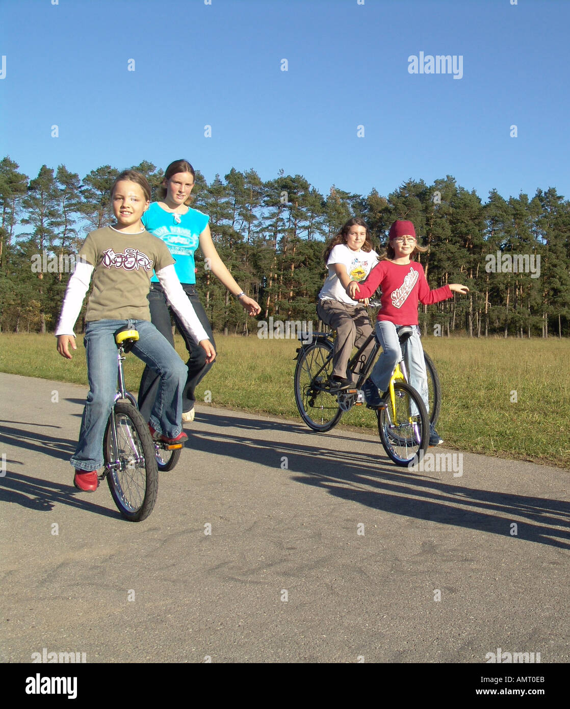 children two girls 10 14 years unicycle cycle sport circus skill ...