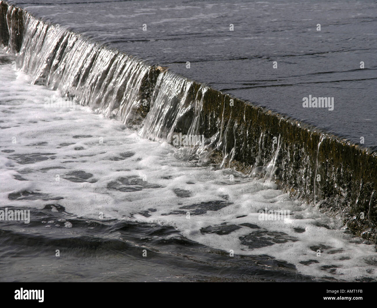Water flowing over a concrete step Stock Photo - Alamy