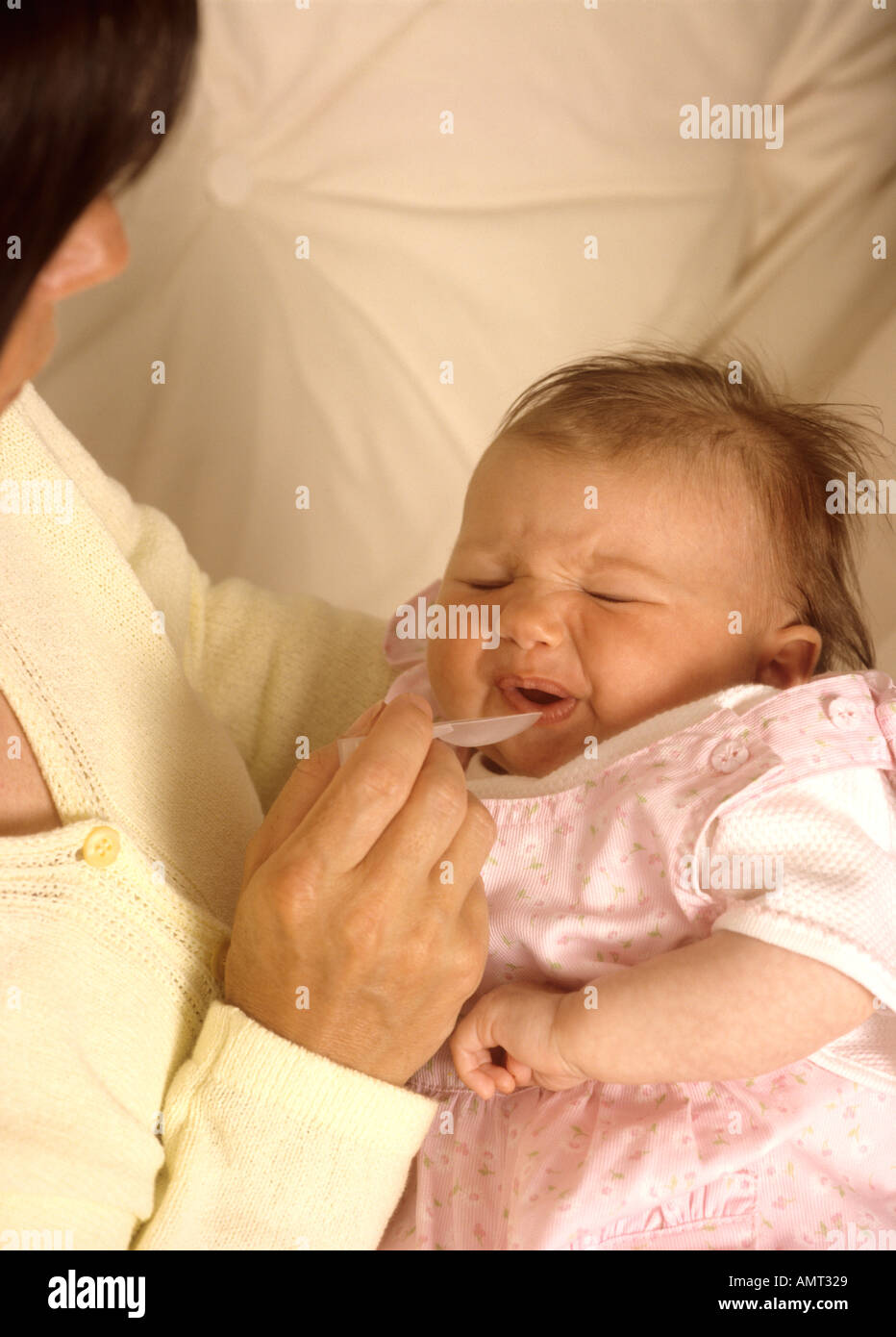 British mother dispensing medicine to her baby girl, Corvid-19 Corvid19 ...