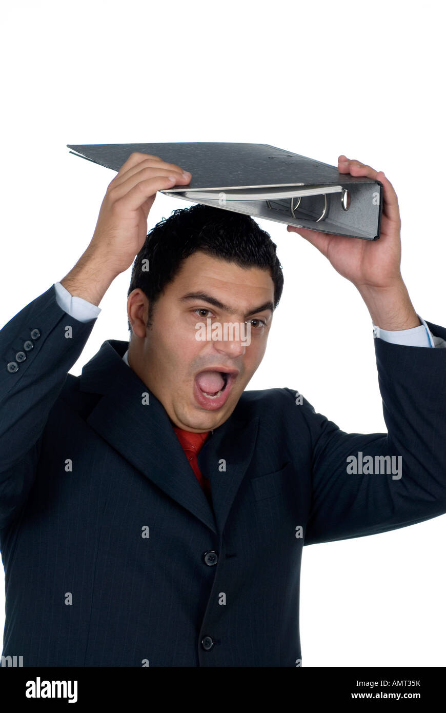 Angry employee holding binder over his head Stock Photo - Alamy