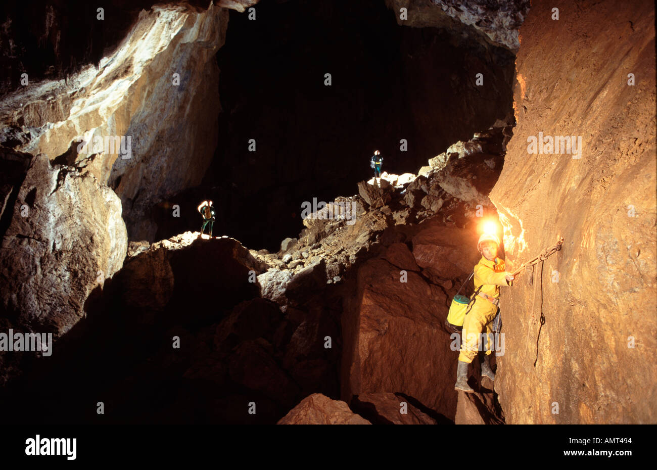 A female caver on a rope traverse in the Pierre St Martin cave system ...
