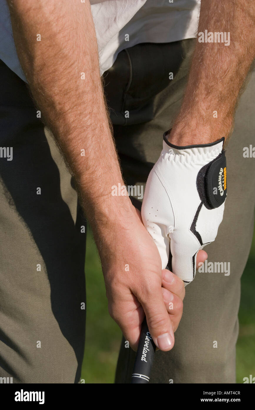 Male golfer demonstrating correct grip on handle of club Stock Photo ...