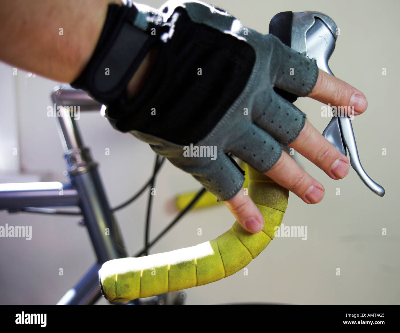 Close up shot of cyclists forearm and hand with gloves holding onto ...