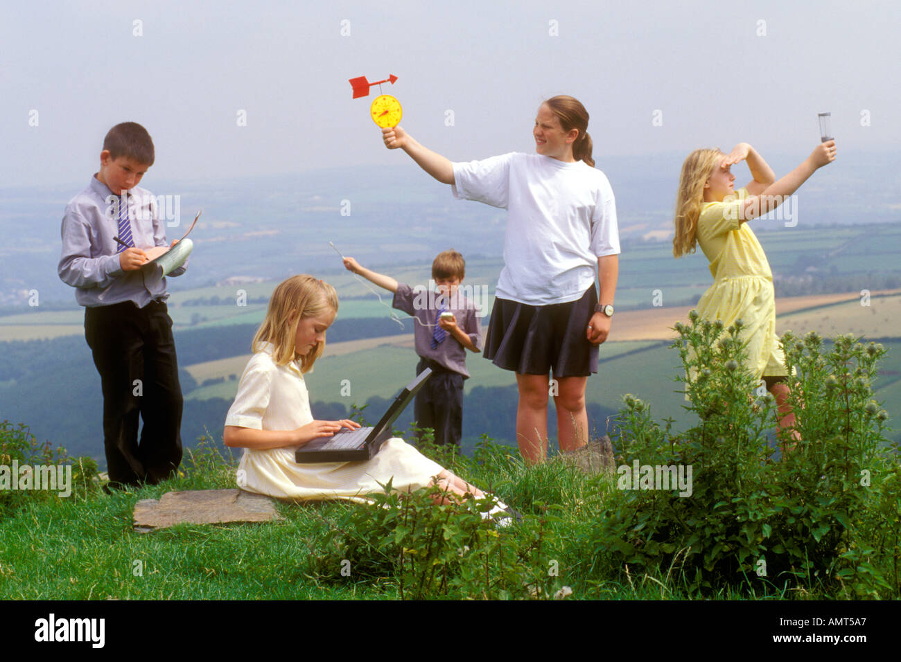 School pupils record the wind speed direction and temperature on a ...