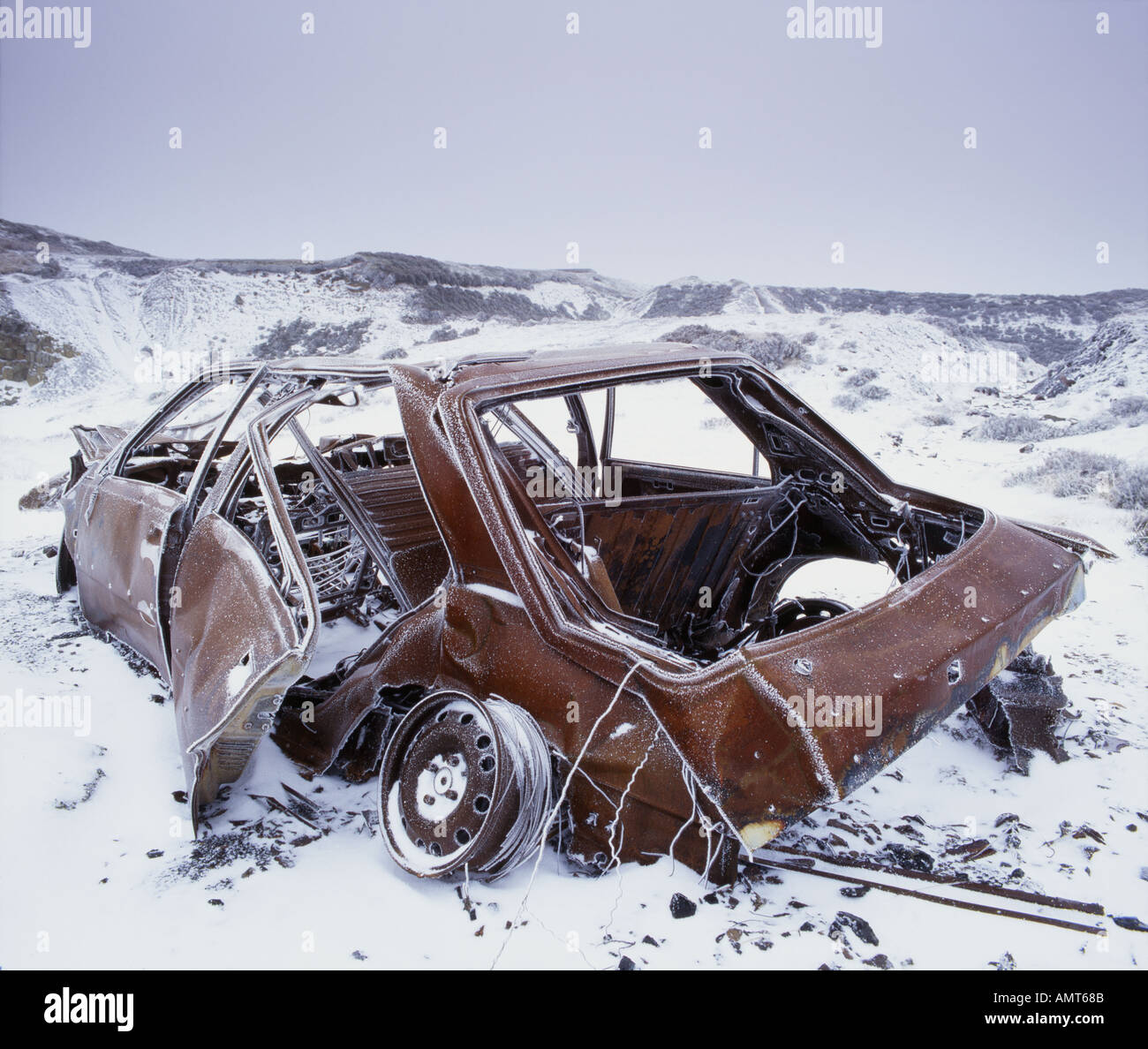 Abandoned car wreck in snowy landscape Stock Photo - Alamy