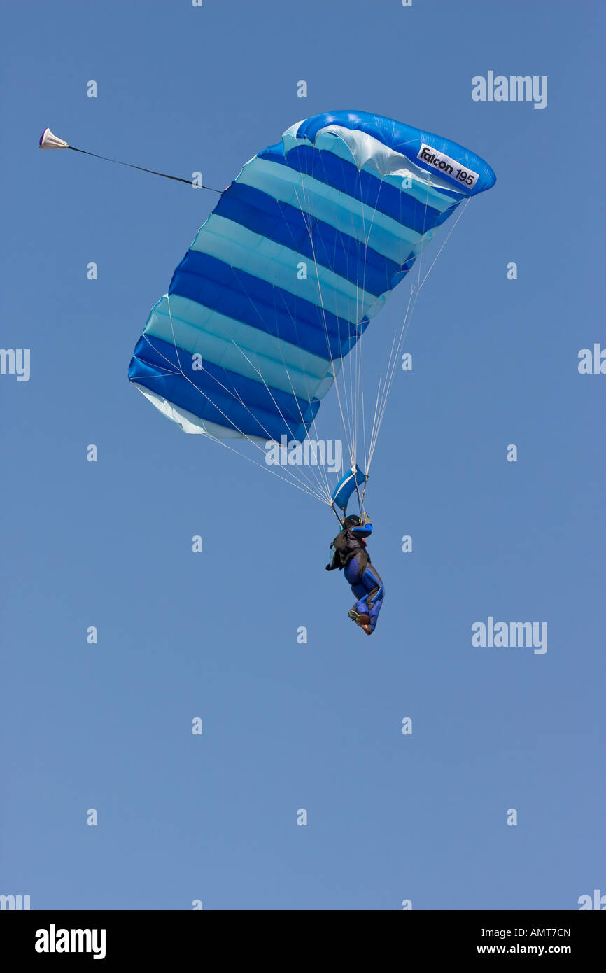 Skydiver with blue parachute Stock Photo - Alamy