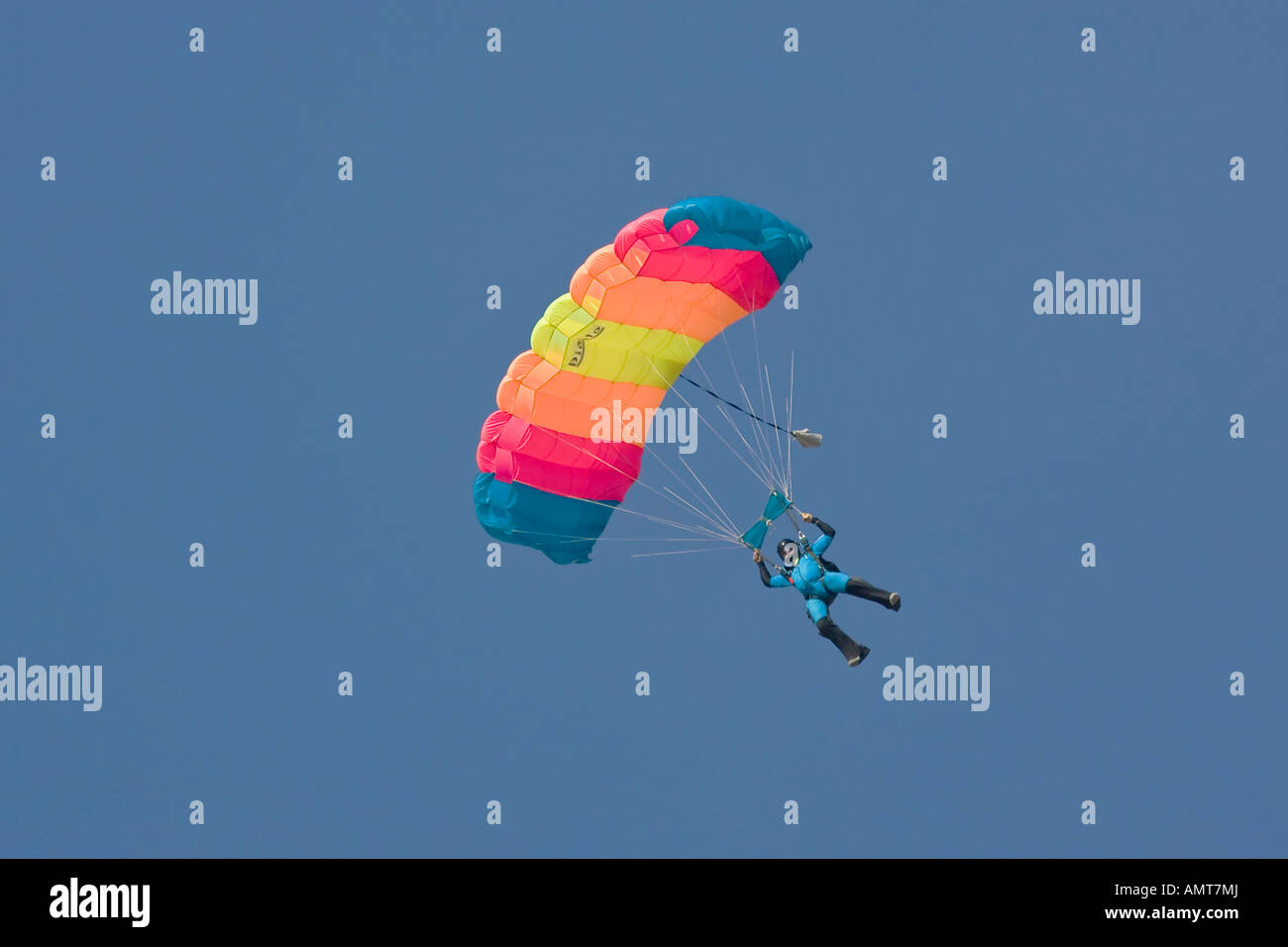 Skydiver with rainbow colored parachute Stock Photo - Alamy
