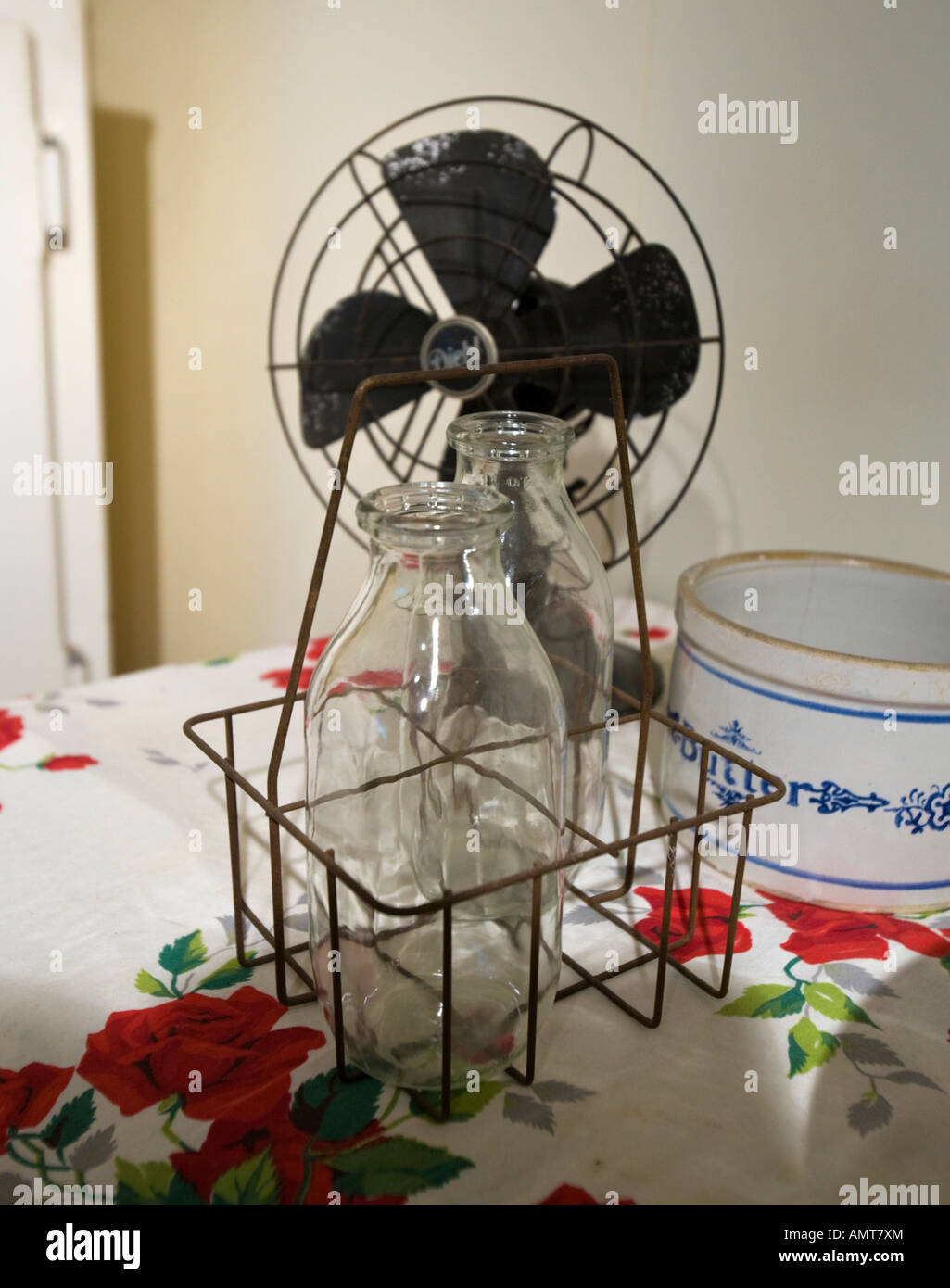 Early fan and empty milk bottle on a table Stock Photo - Alamy
