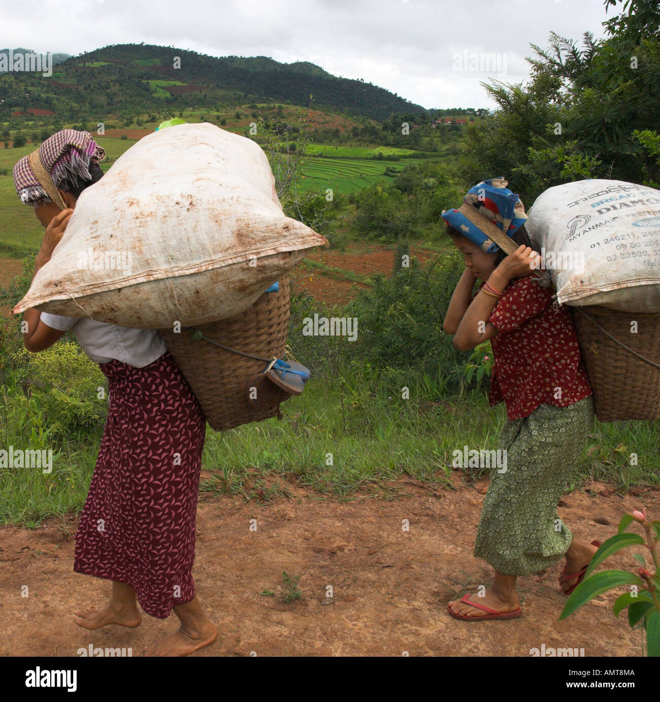 Myanmar Burma Shan State Shabin area view with two women carrying heavy ...