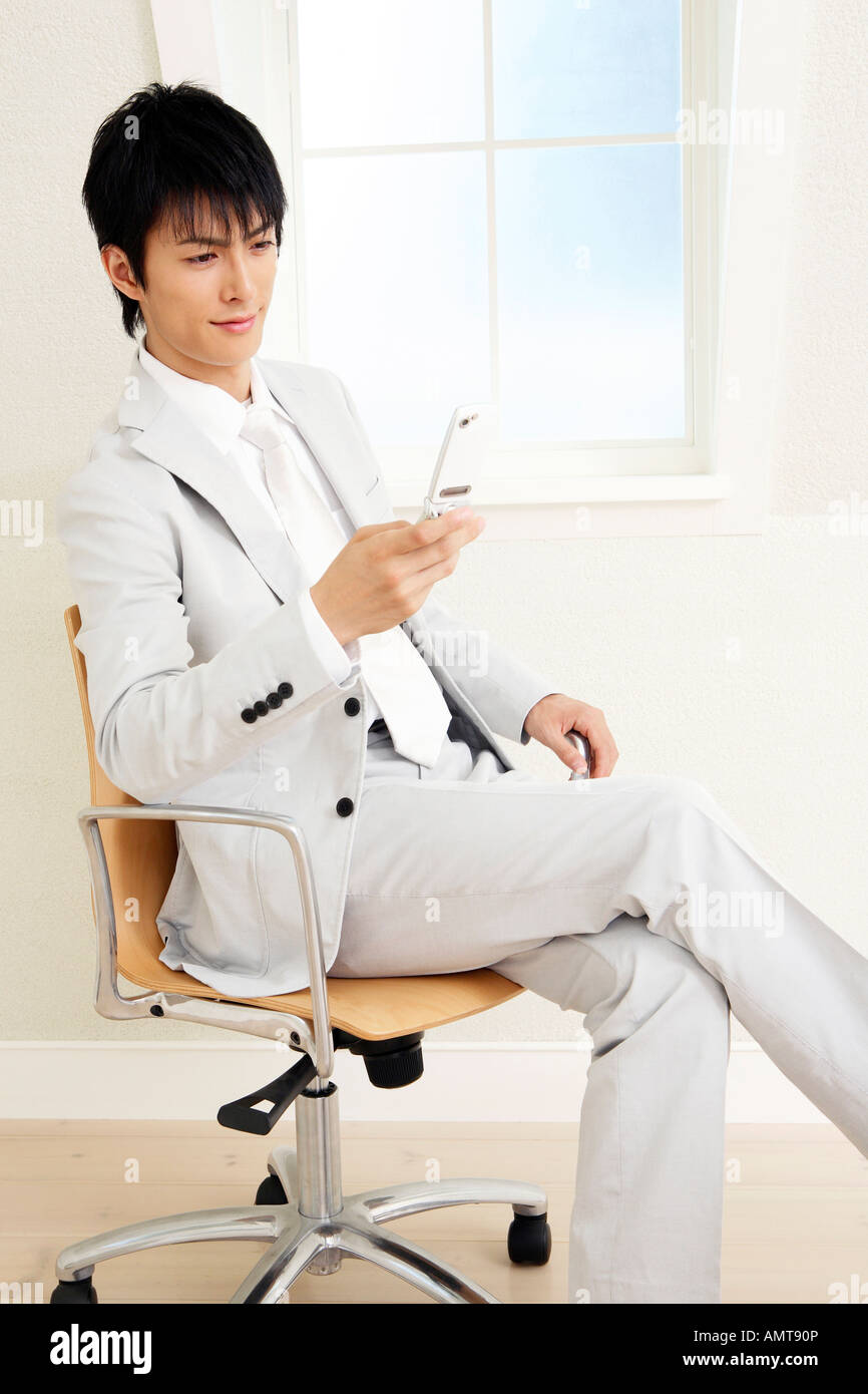 Office worker checking a cell phone Stock Photo - Alamy