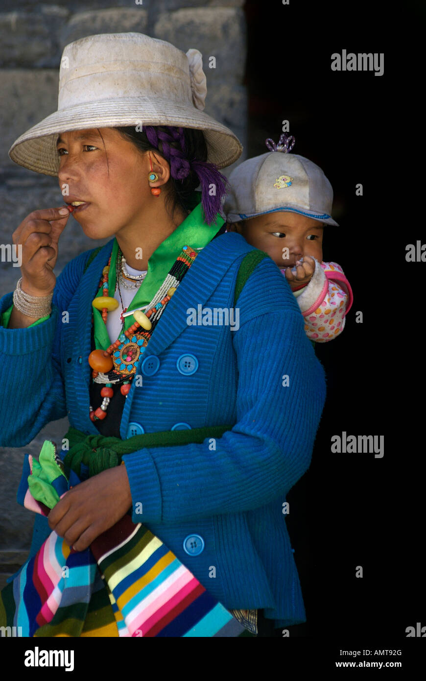 Tibetan woman with a baby on her back Sakya monstery Tibet Stock Photo ...