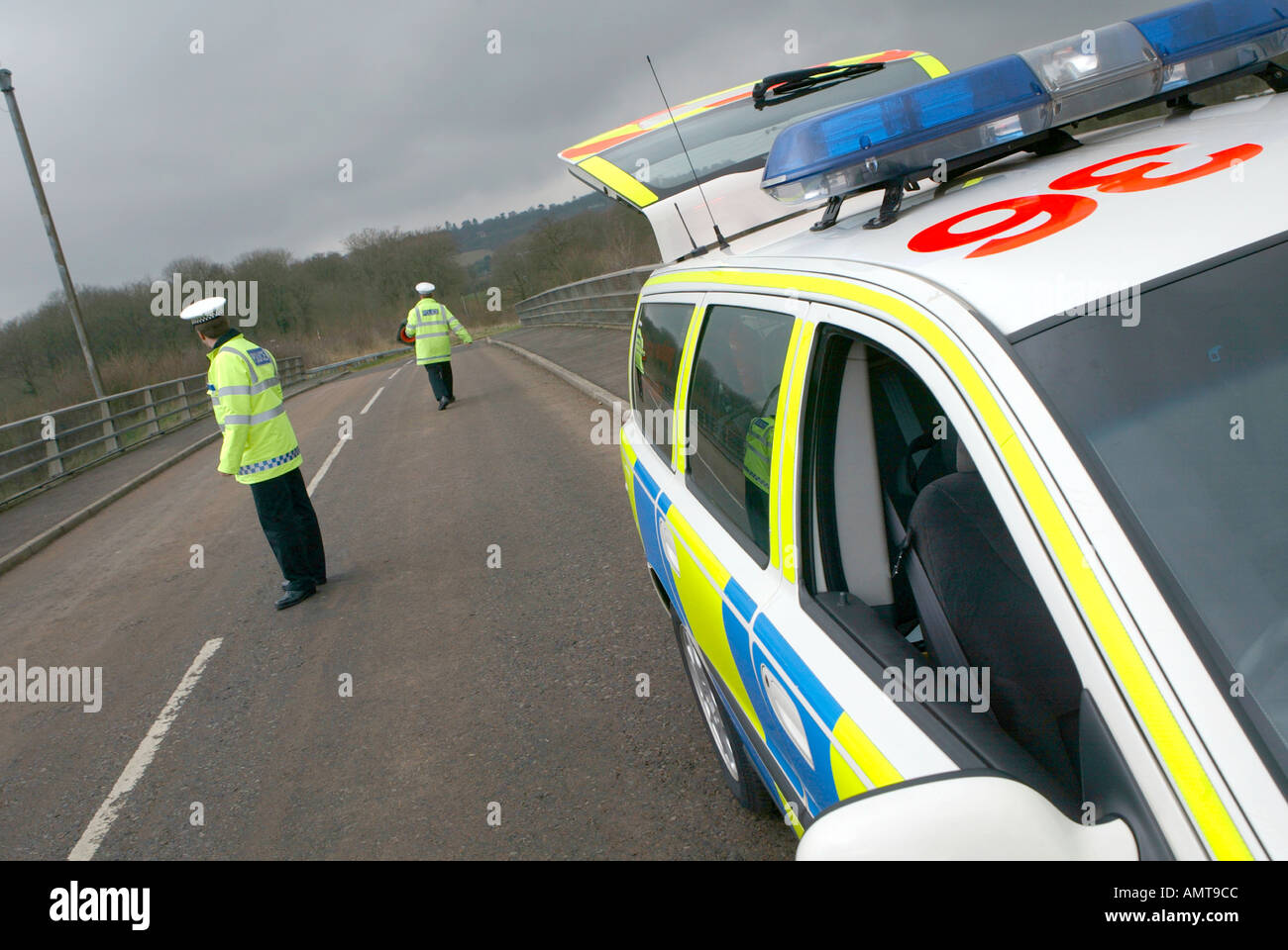 British Traffic Police Officers examine the scene of a road traffic ...