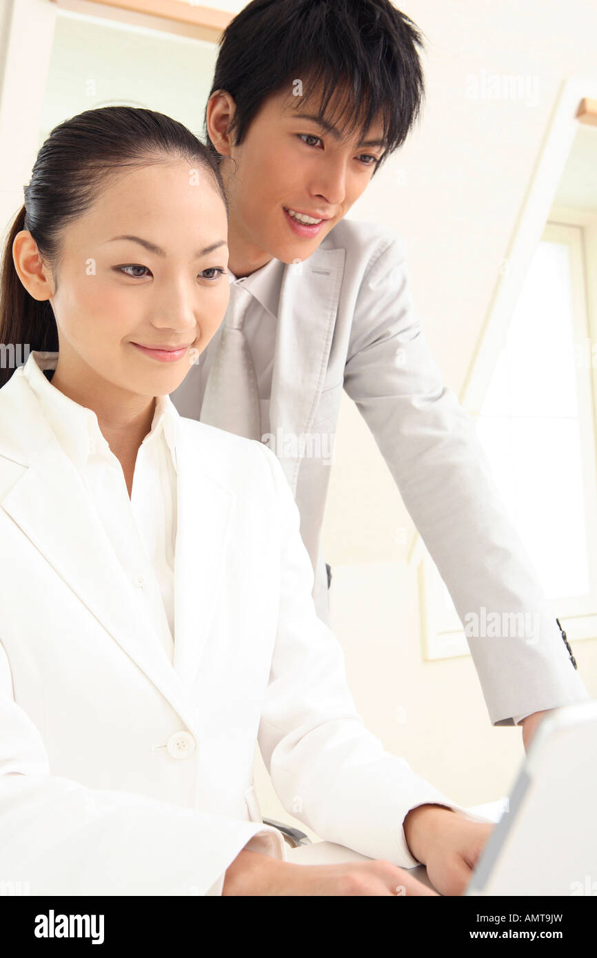 Office workers looking at PC monitor Stock Photo - Alamy