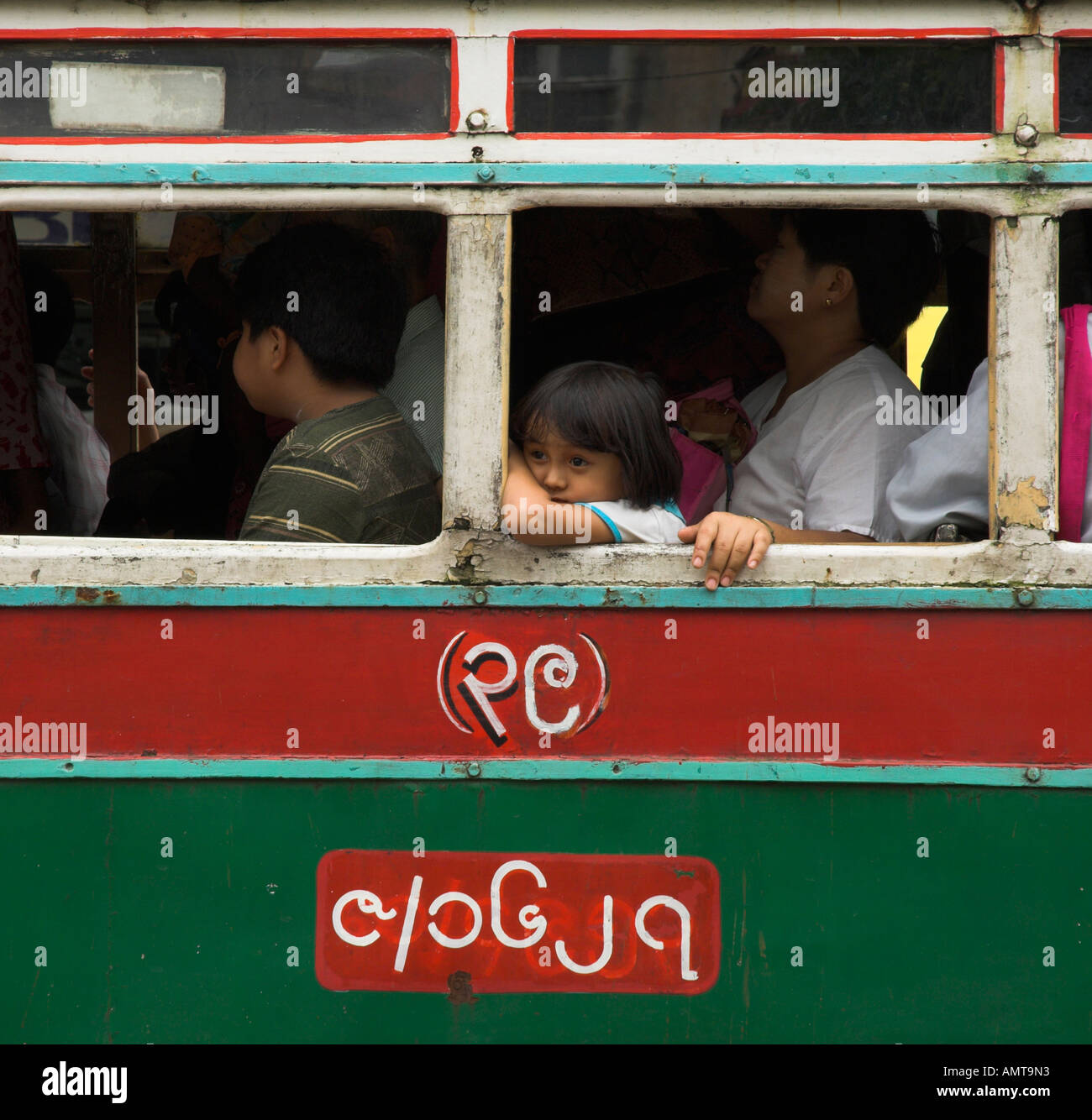 Myanmar Burma Yangon female child at the window of a typical city bus ...