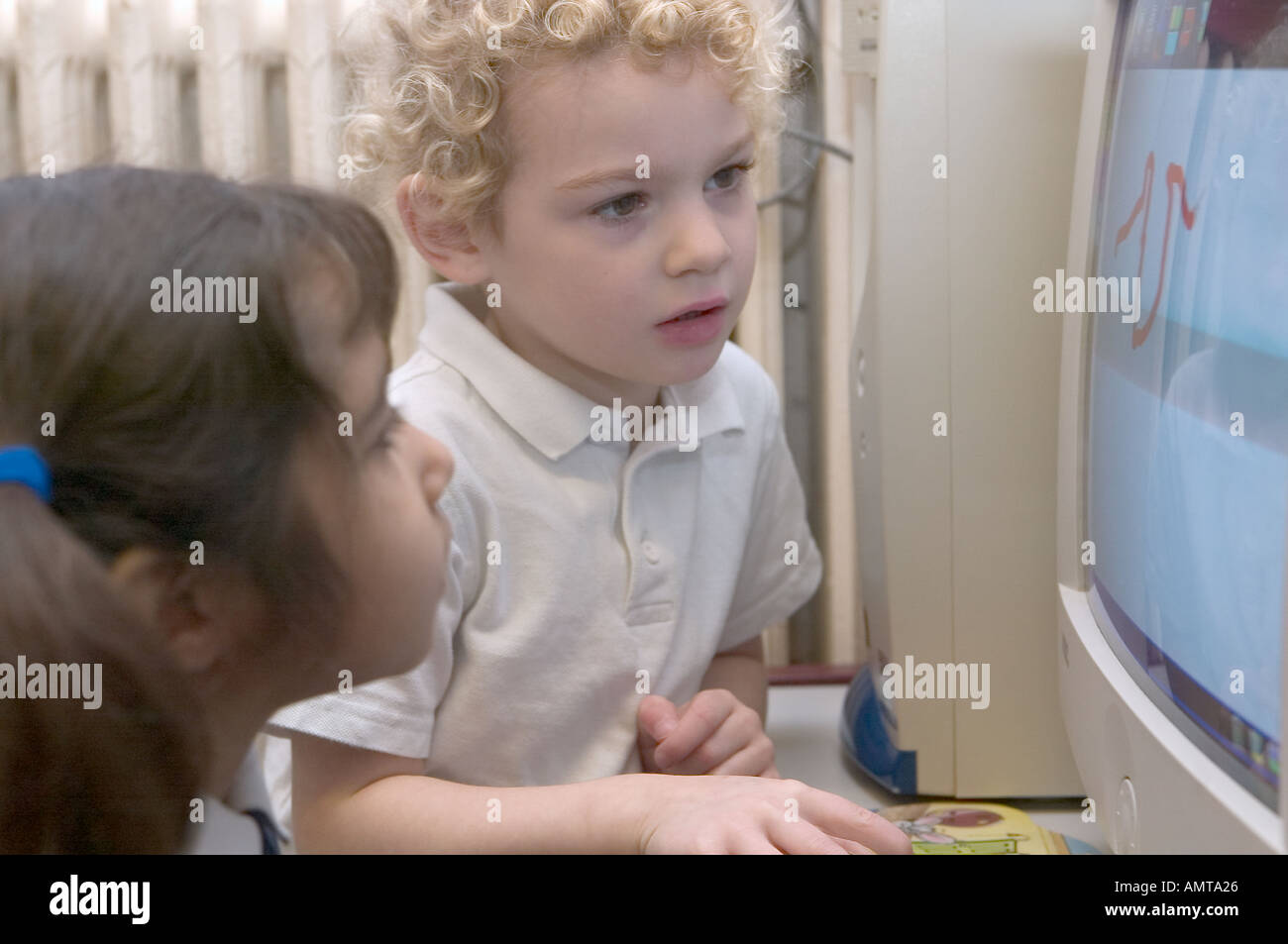 Children using a computer in an infant school classroom Stock Photo - Alamy