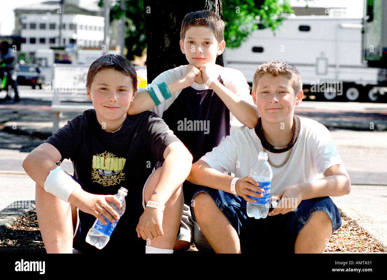 3 seventh grade boys with bottled water pose for picture Stock Photo - Alamy