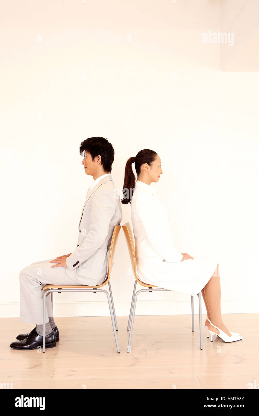 Office workers sitting on a chair Stock Photo - Alamy