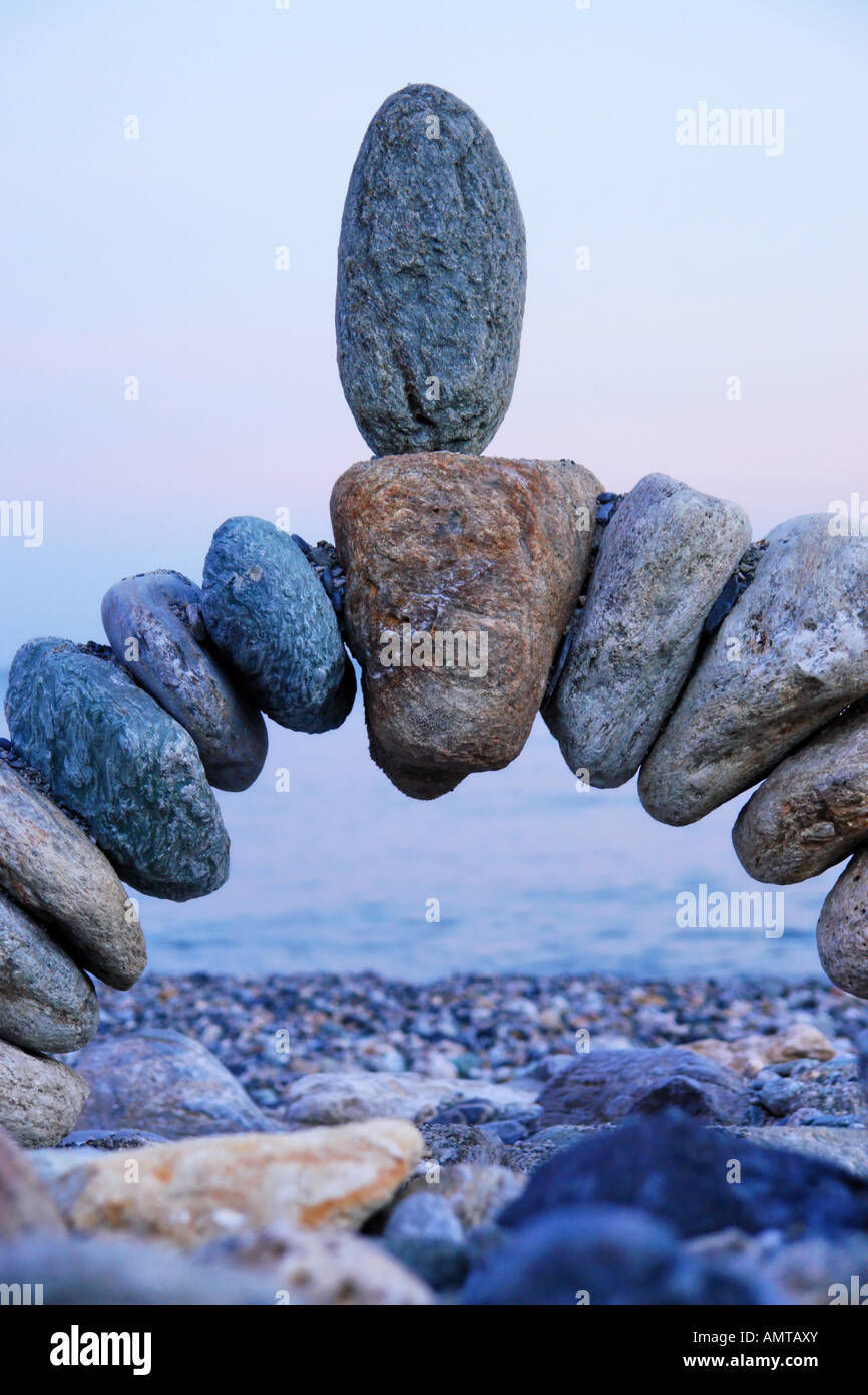 photo of stone in balance at the beach Stock Photo - Alamy