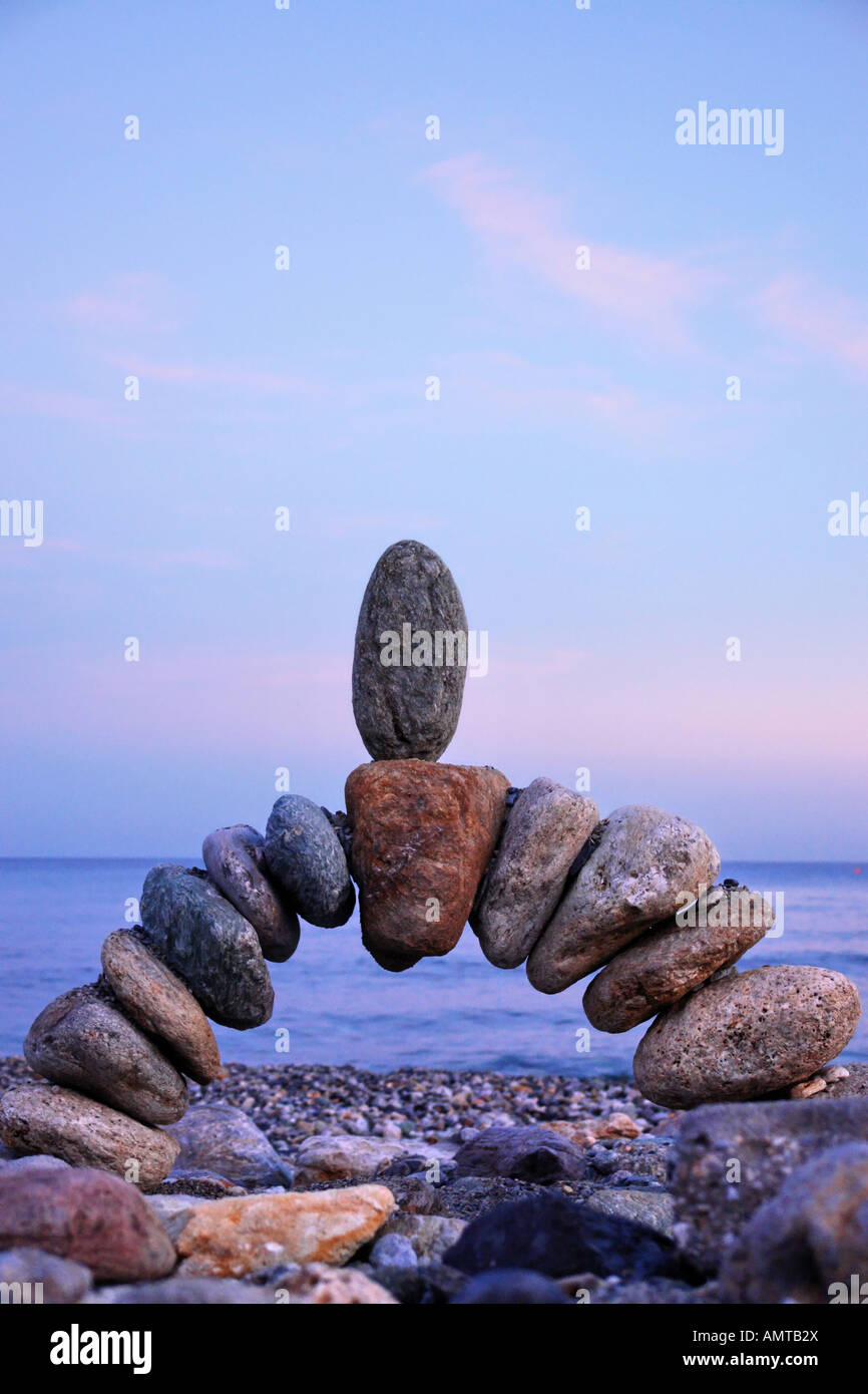photo of stone in balance at the beach Stock Photo - Alamy