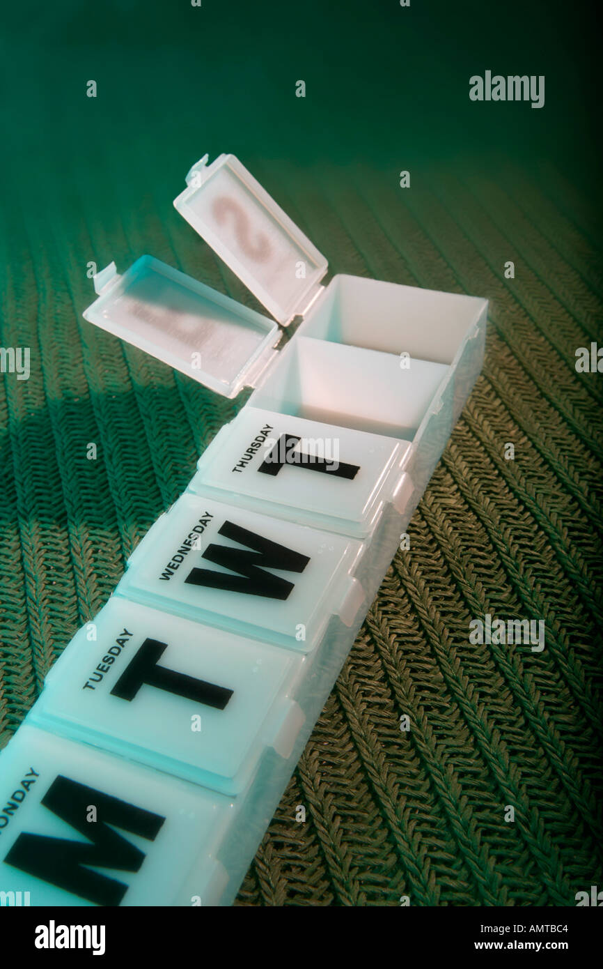 A pill organizer box with Monday s through Thursday s compartments ...