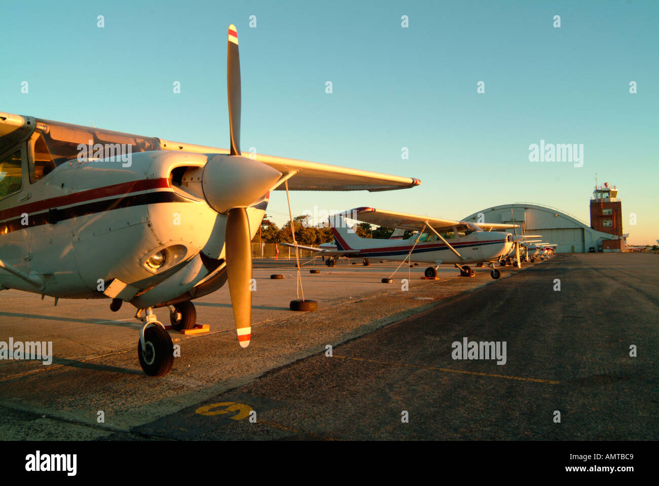 A row of single engine planes at an airport Stock Photo - Alamy