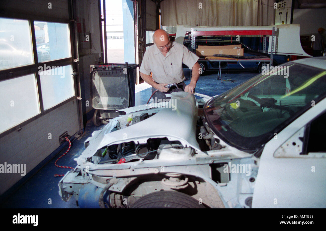 Repairman works on an automobile in a repair shop Stock Photo - Alamy