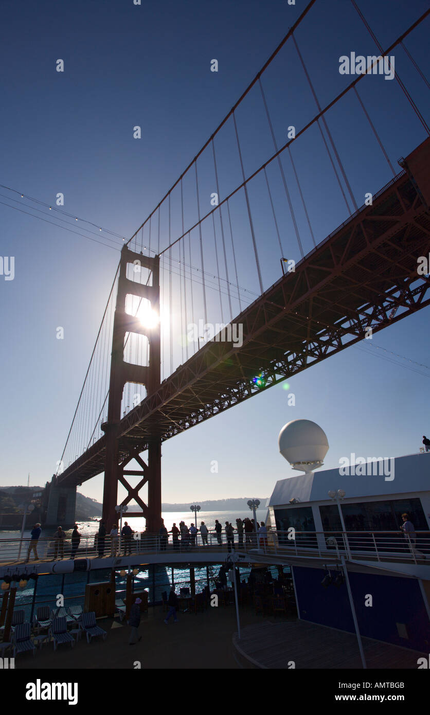 Passenger cruise ship sailing underneath the Golden Gate Bridge ...