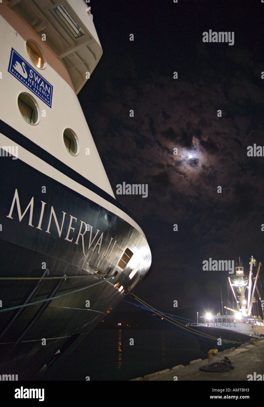 Full moon over bow section of liner Minerva 2 with fishing trawler in ...