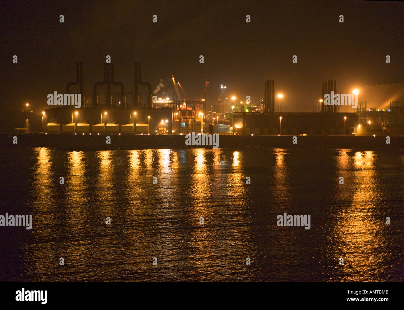Industrial complex at night and dockside at port of Puerto Quetzal on ...