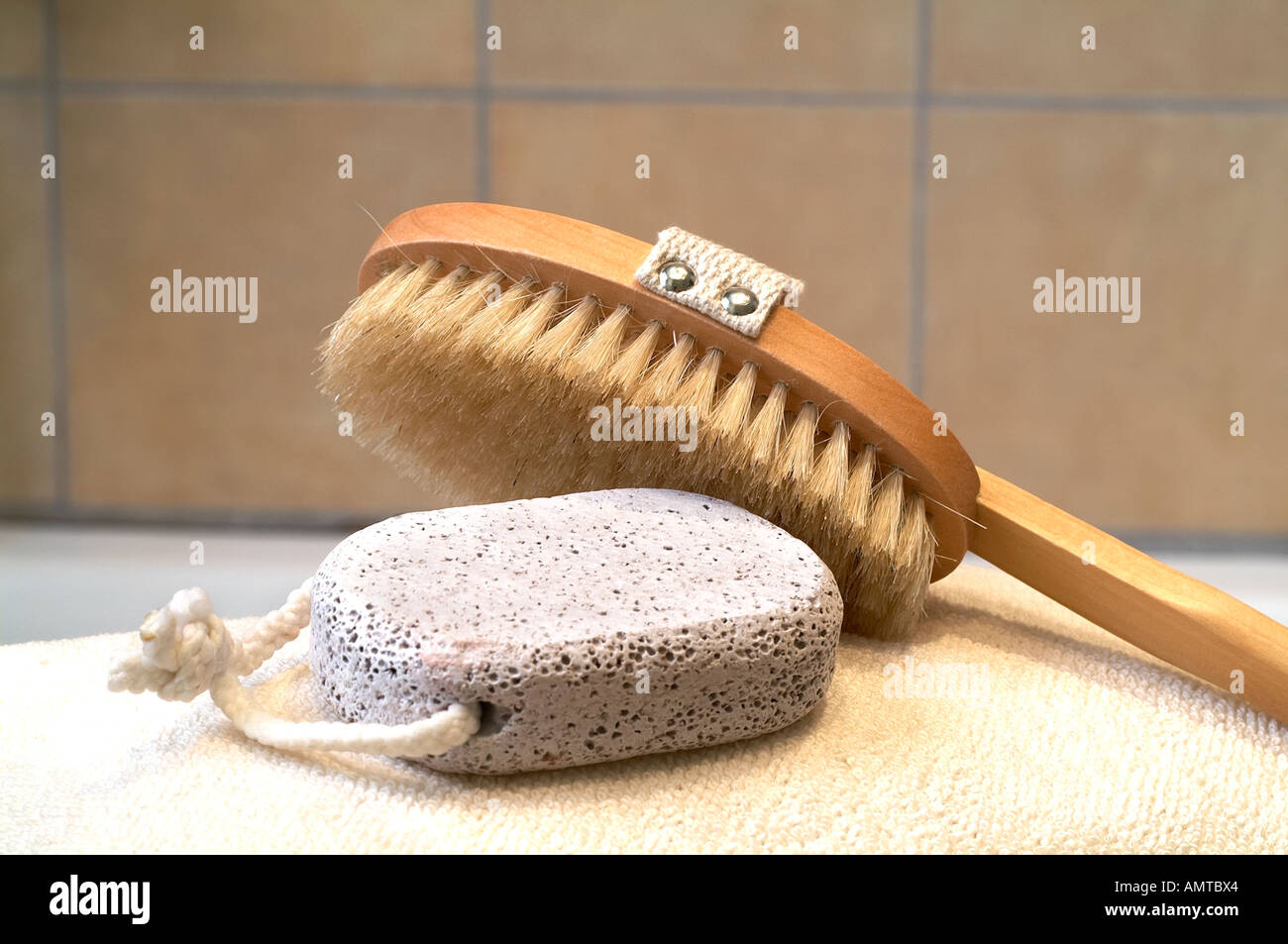 Bath brush and pumice stone on a towel Stock Photo - Alamy