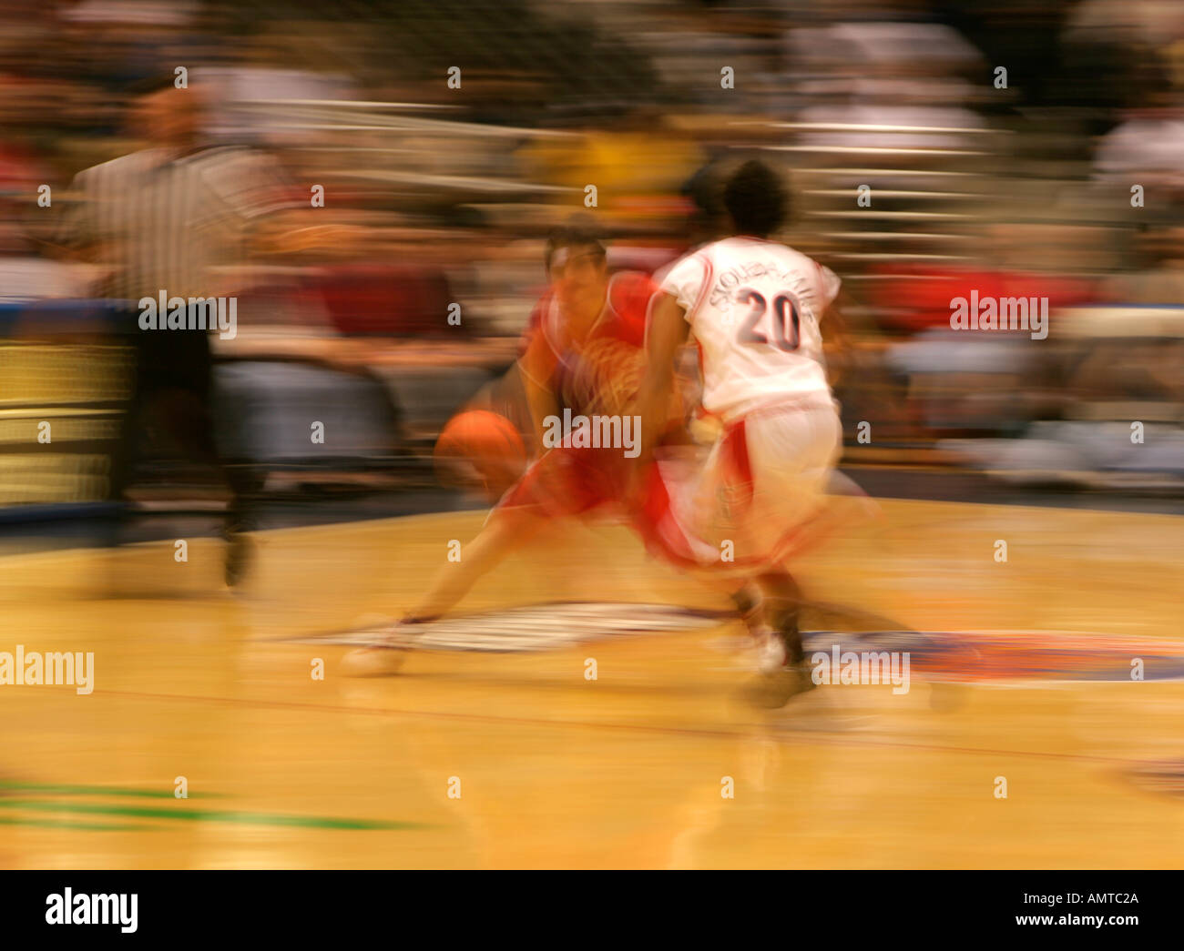 A slow shutter speed shot of a basketball player making a shot Stock ...