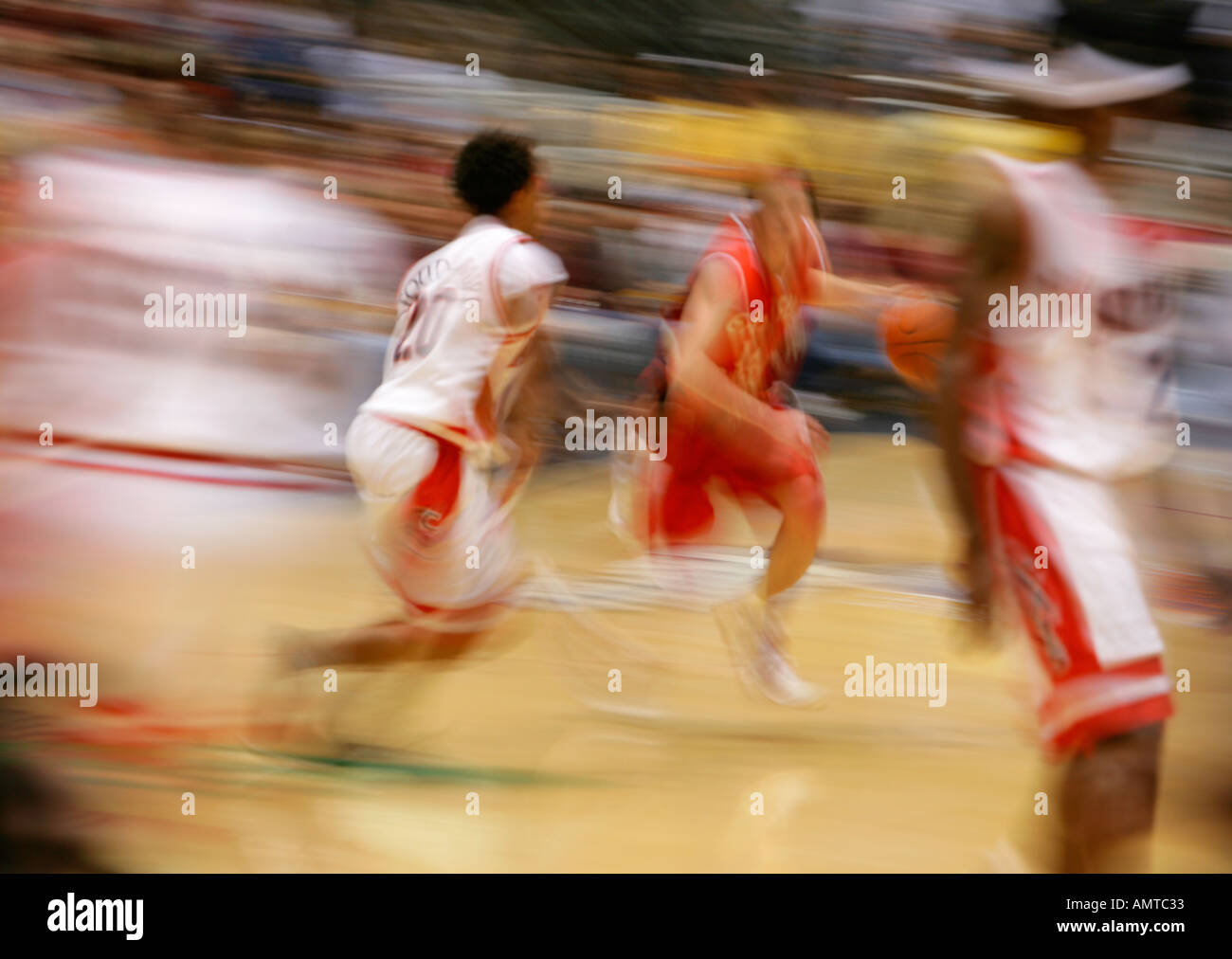A slow shutterspeed shot of a basketball player making a shot Stock ...