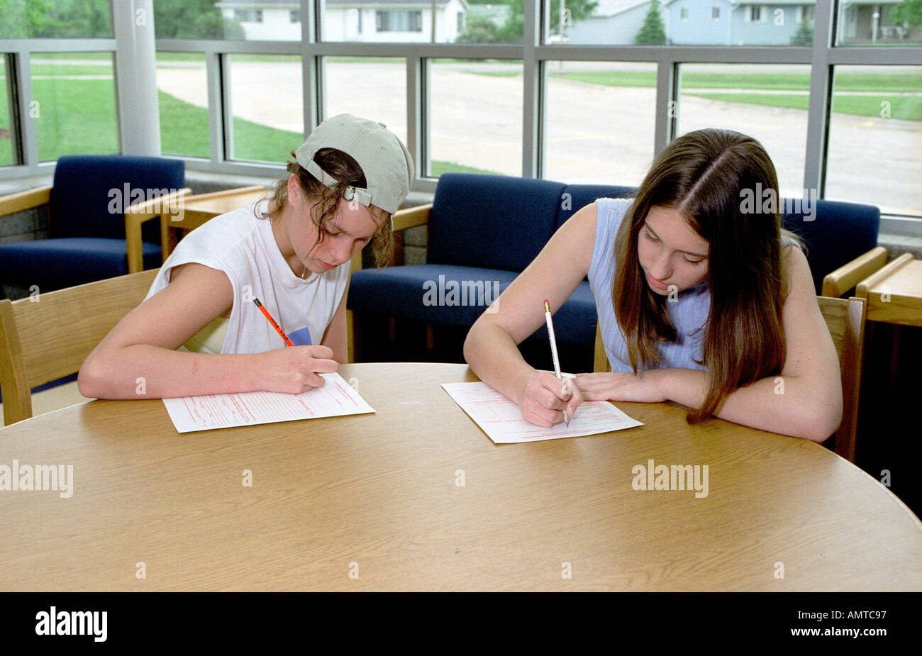 Two job applicants one appropriately dressed one not fill out an ...