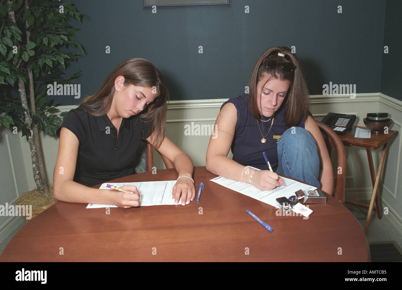 Two job applicants one appropriately dressed one not fill out an ...