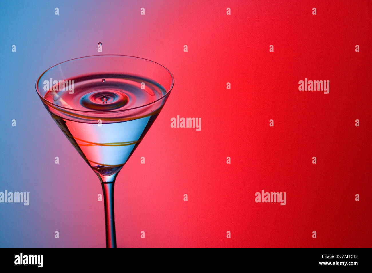 Water Drop into Martini Glass Stock Photo - Alamy