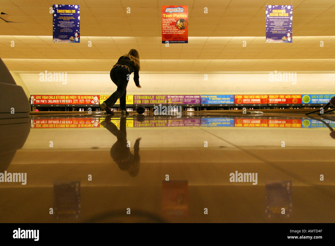bowling alley ten pin girl throwing a strike sport leisure fun pleasure ...