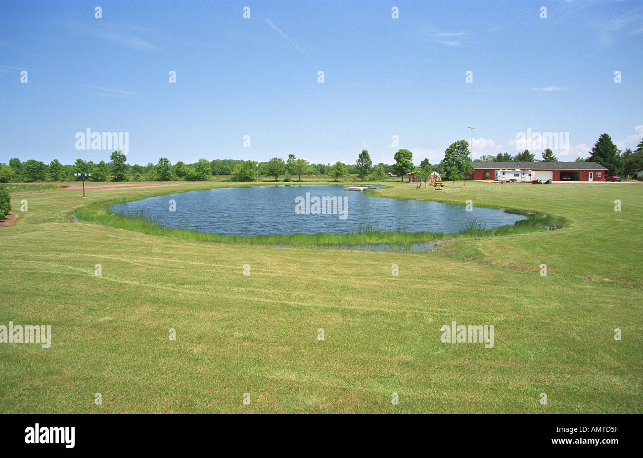 A view of a small pond showing land on all sides Stock Photo - Alamy