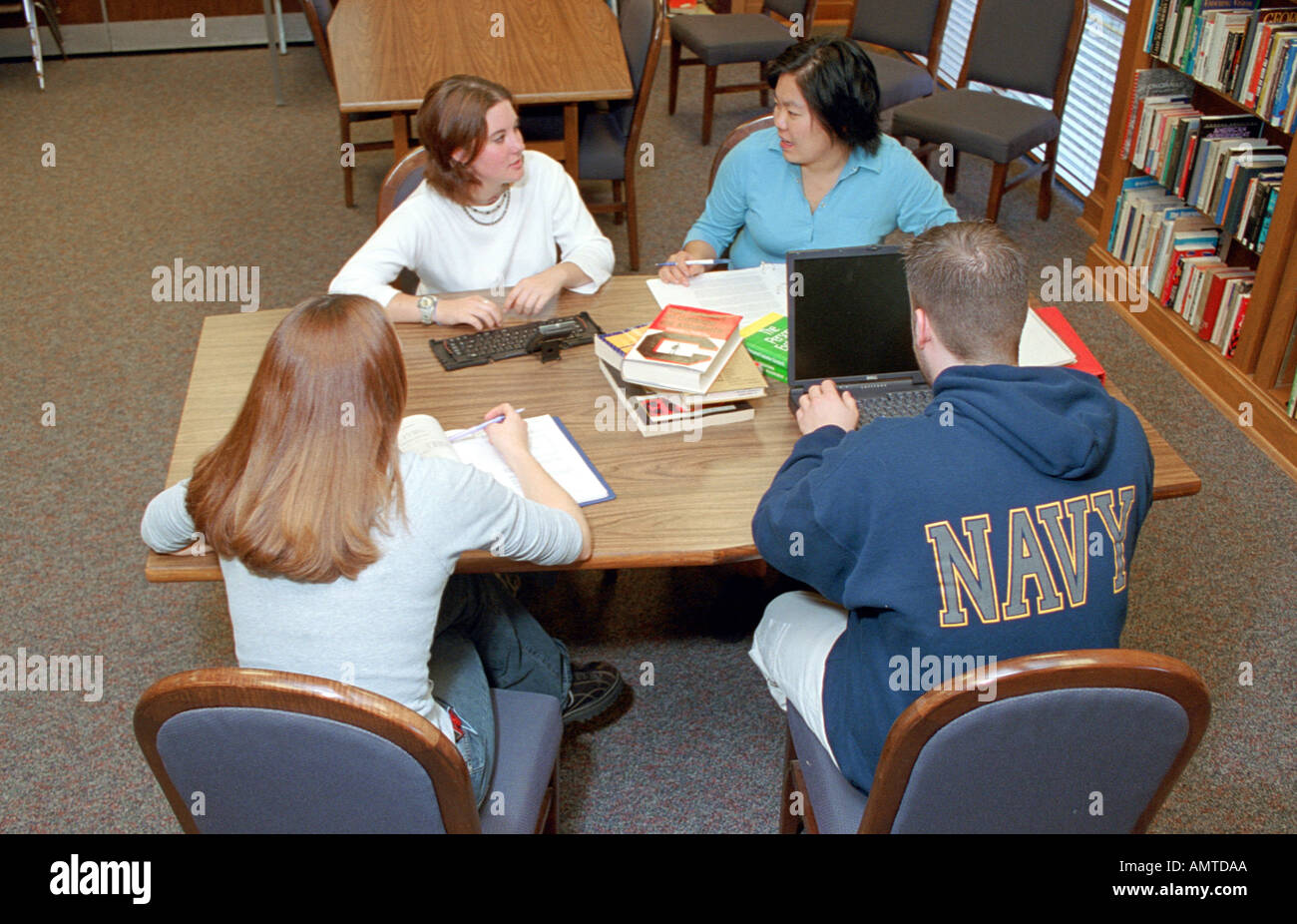 College students work in a group with professor on a research project ...