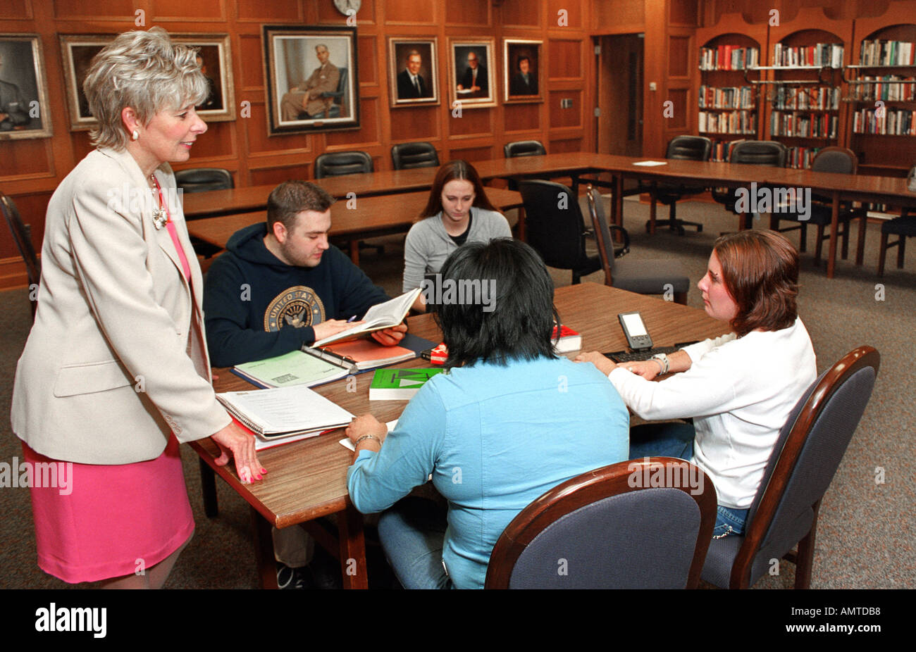 College students work in a group with professor on a research project ...