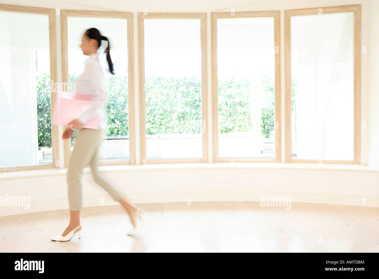 Office lady walking in a room Stock Photo - Alamy